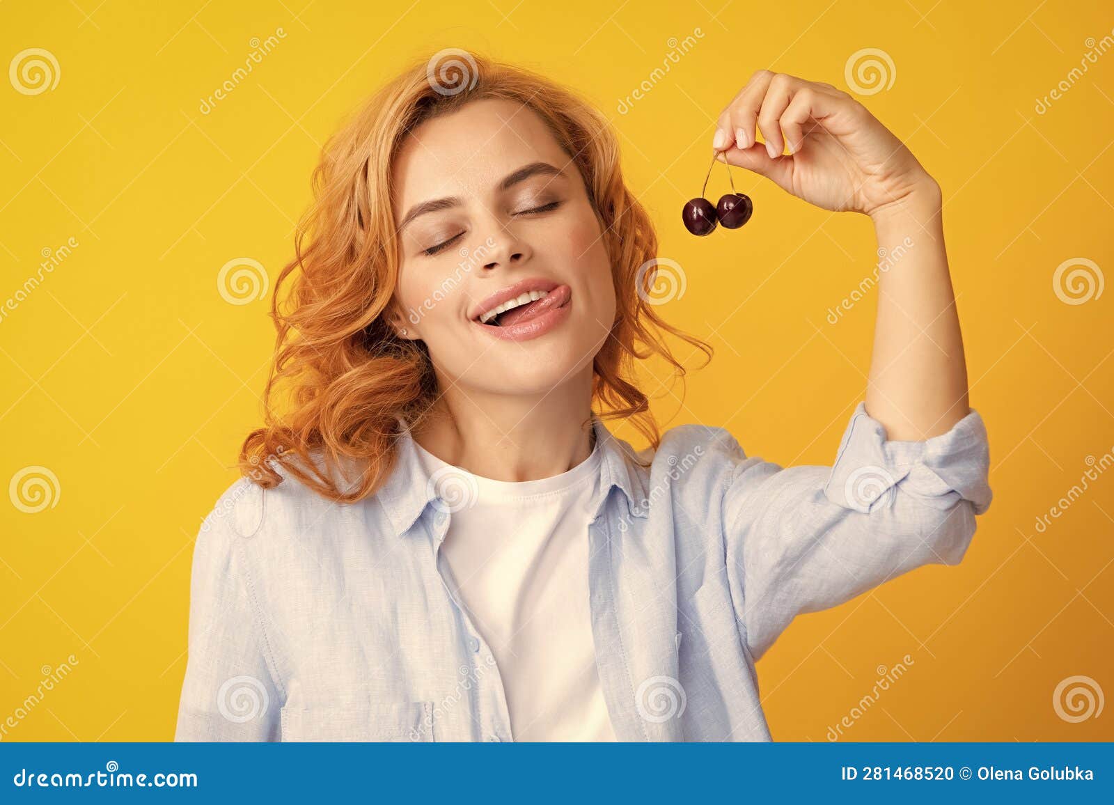 Charming Woman with Cherry Licking Lips, Isolated on Yellow. Stock ...