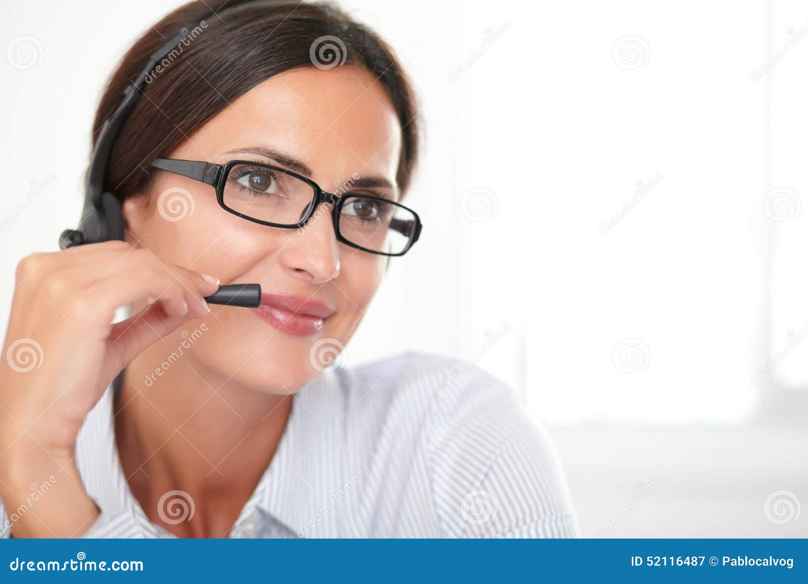 Charming Young Employee Conversing on Headphones Stock Image - Image of ...