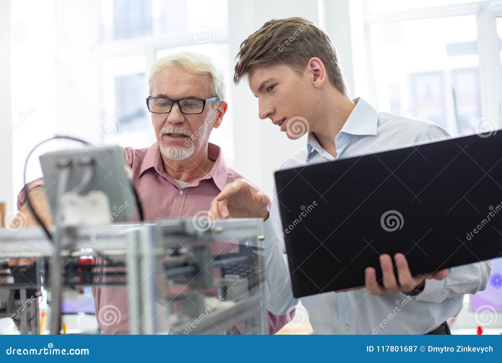 Charming Young Intern and His Supervisor Using 3D Printer Together ...