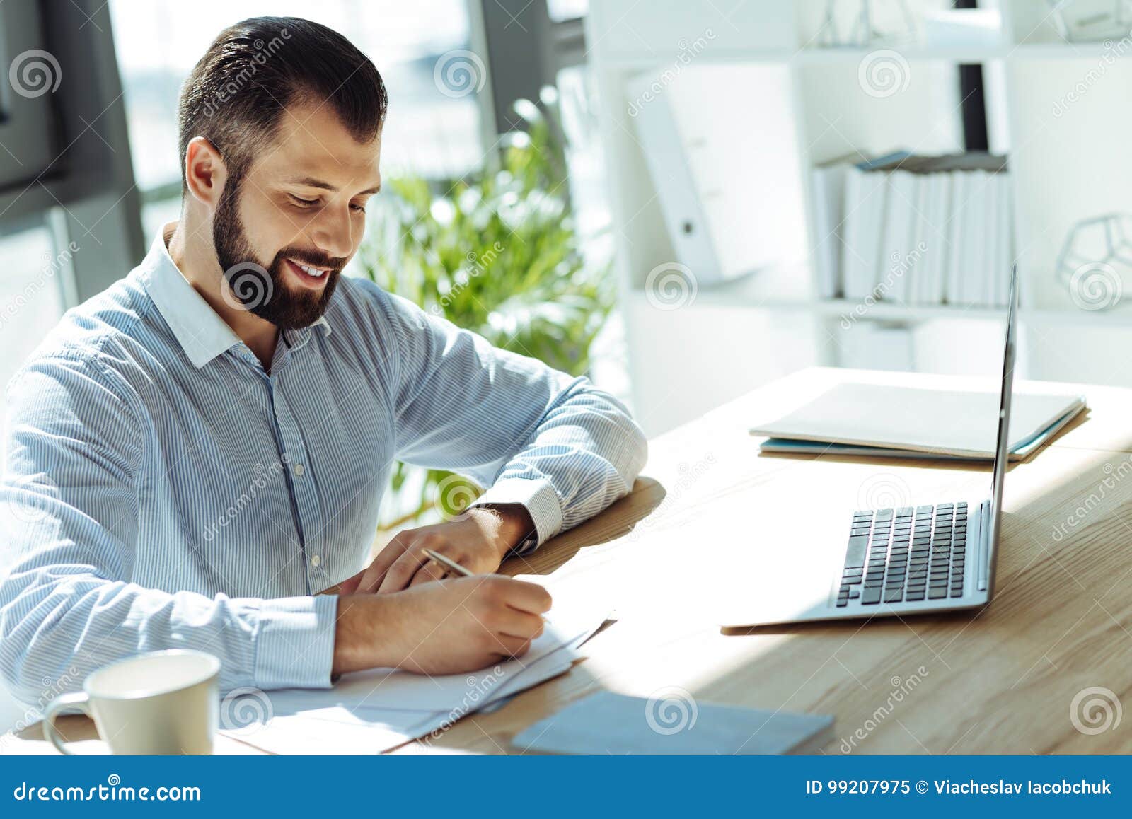Charming Young Man Making Notes in the Office Stock Image - Image of ...