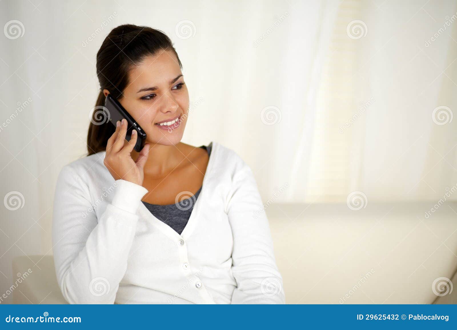 Charming Young Woman Conversing on Cellphone Stock Photo - Image of ...