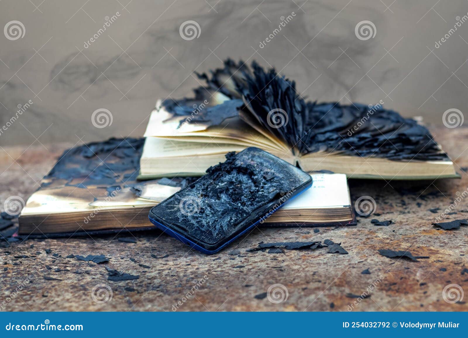 Charred Books and a Mobile Phone after the Fire. Careless Handling of ...