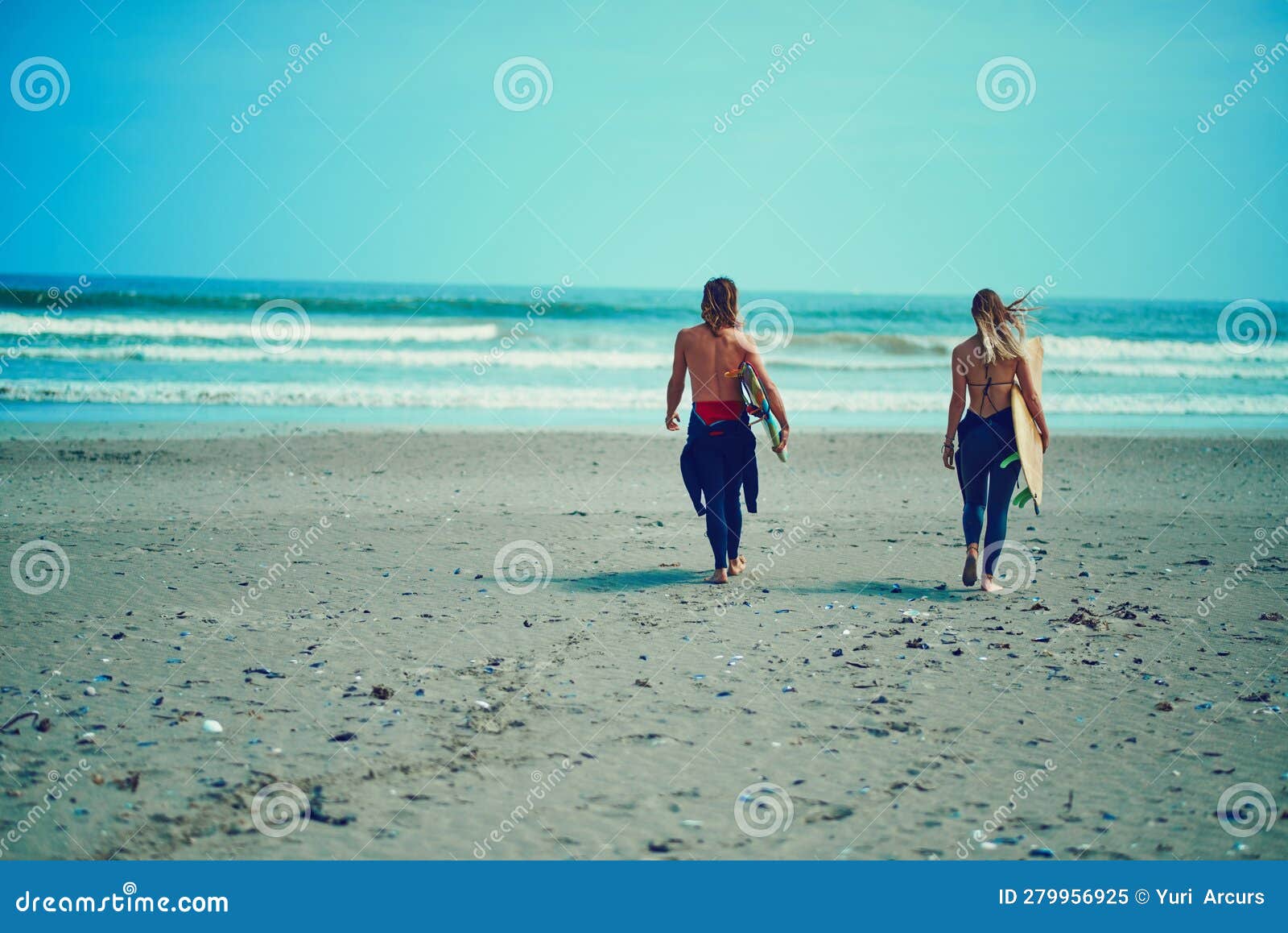 Chasing Waves is Our Top Priority. a Young Couple Walking on the Beach ...