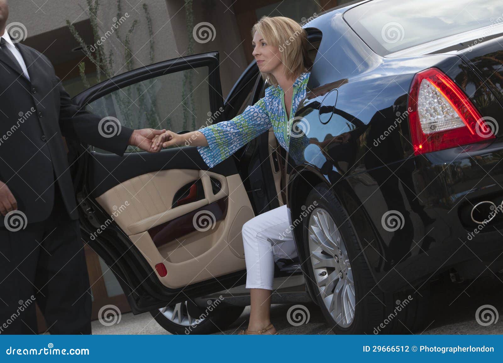 Chauffeur Helps Woman Get Down from Car Stock Photo - Image of luxury ...