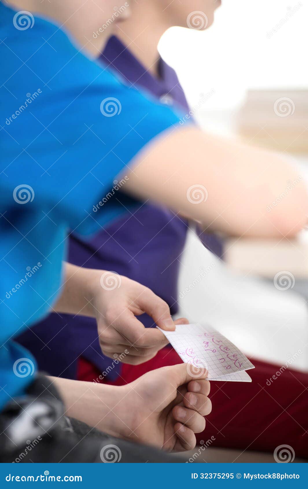 Cheating at the Exam. Close Up of Pupils Passing the Paper with Stock ...