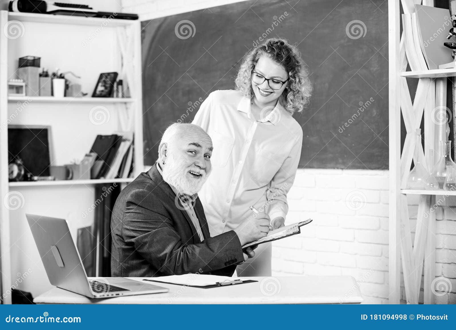 Check Homework. Educator and Student Looking at Book. Explaining ...