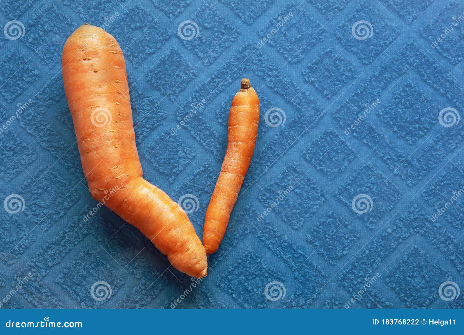 Fresh Curved Carrot On Blue Background. Ugly Vegetables Stock ...