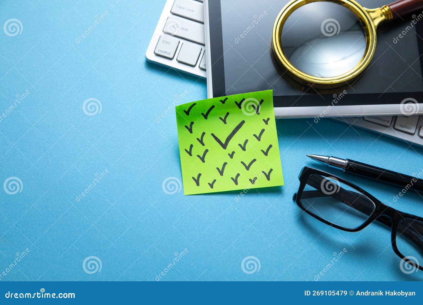 Check Marks on Sticky Note with a Business Objects on the Blue ...