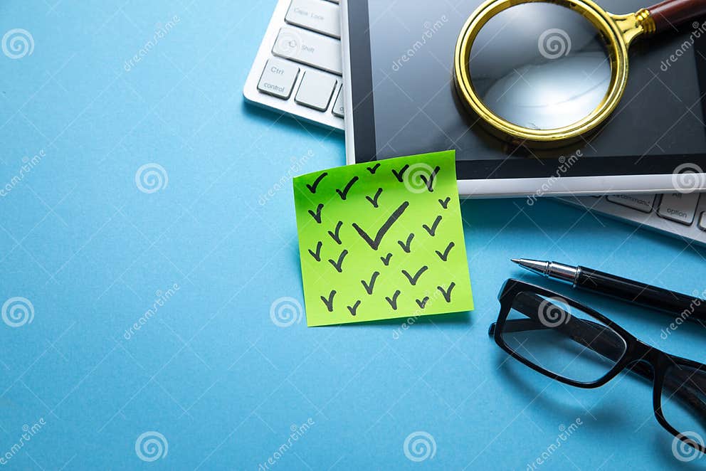 Check Marks on Sticky Note with a Business Objects on the Blue ...