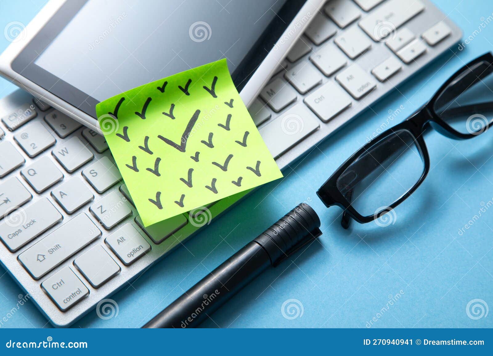 Check Marks on Sticky Note with a Business Objects on the Blue ...