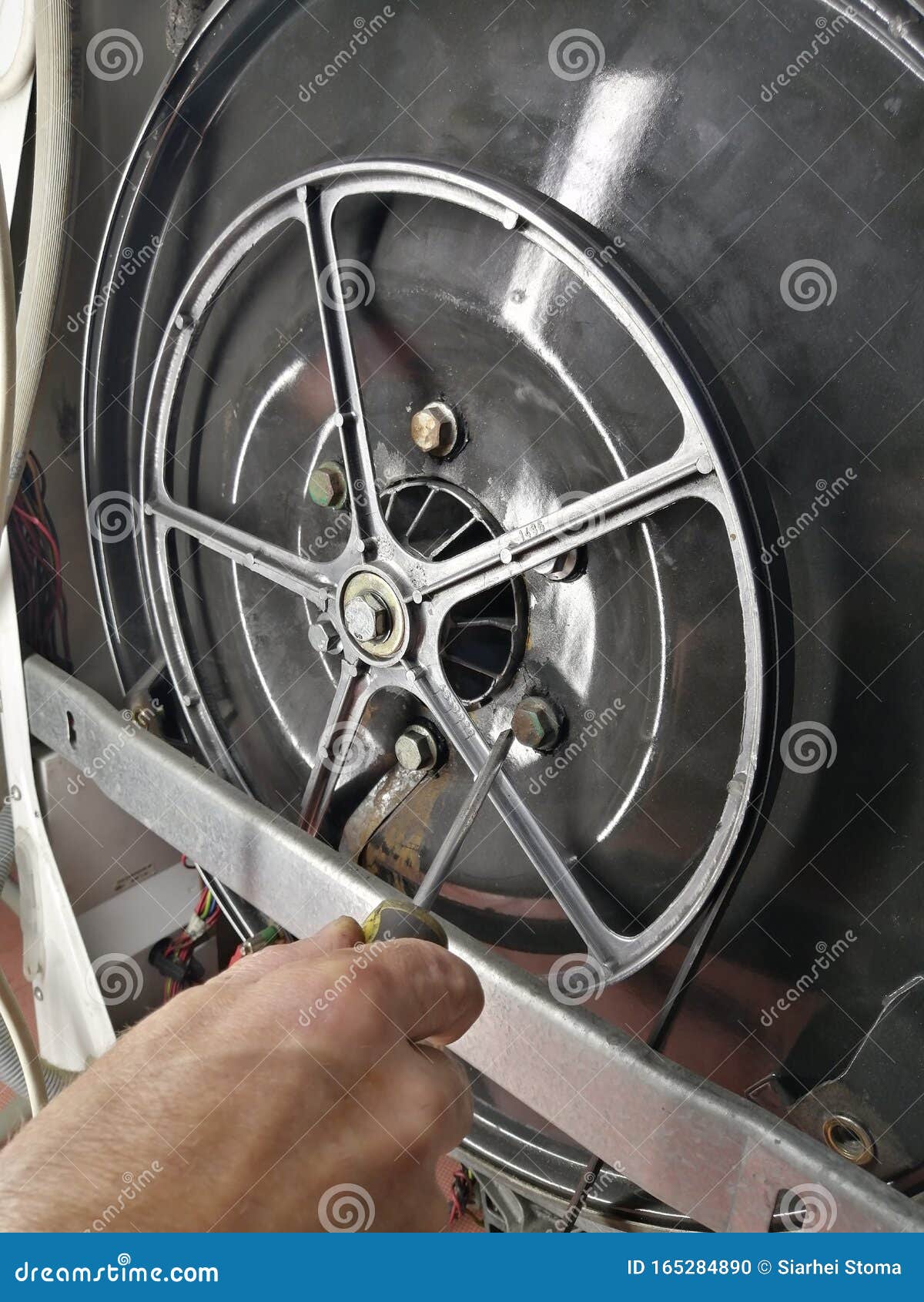 Check with a Screwdriver in the Hand of a Pulley on a Washing Machine ...