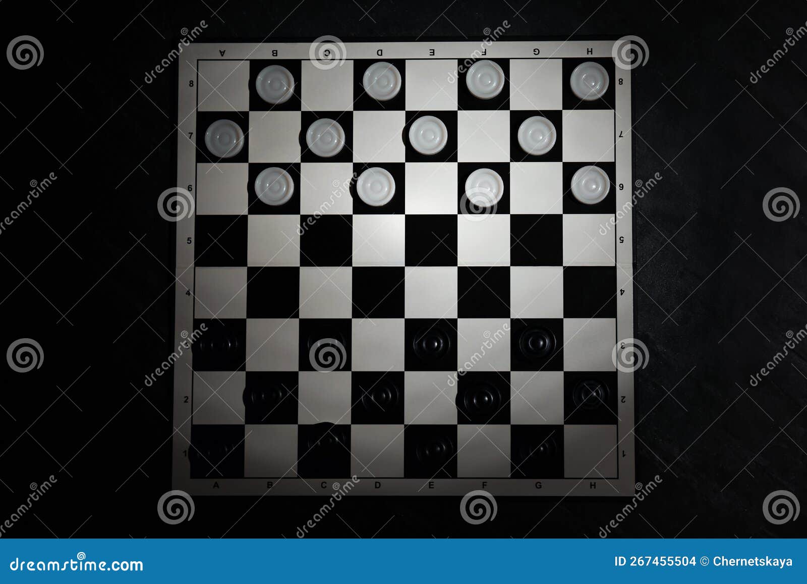 Checkerboard with Game Pieces on Black Table, Top View Stock Photo ...