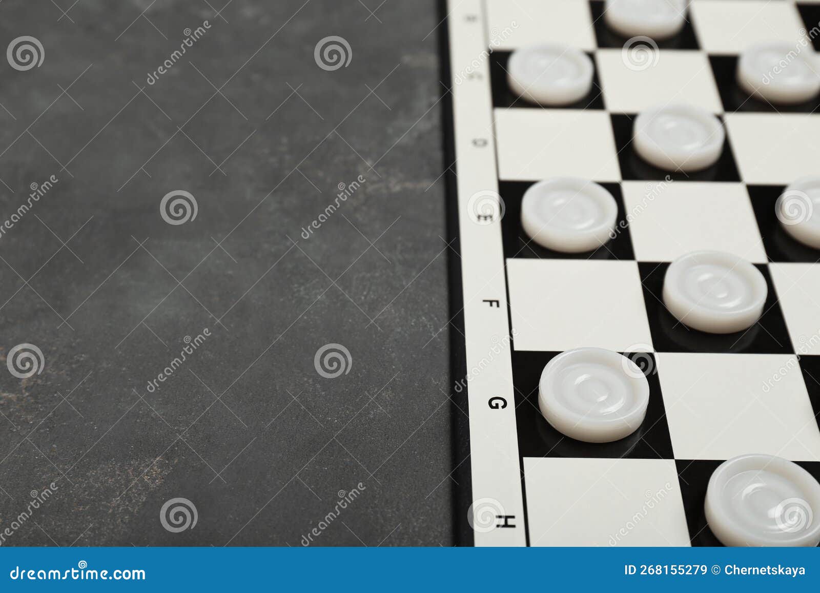 Checkerboard with Game Pieces on Grey Table, Closeup. Space for Text ...