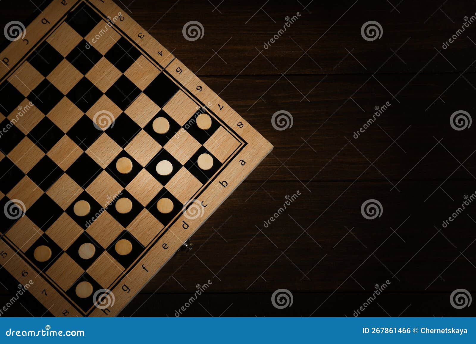 Checkerboard with Game Pieces on Wooden Table, Top View. Space for Text ...