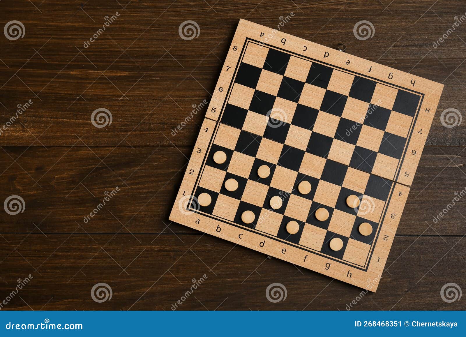 Checkerboard with Game Pieces on Wooden Table, Top View. Space for Text ...