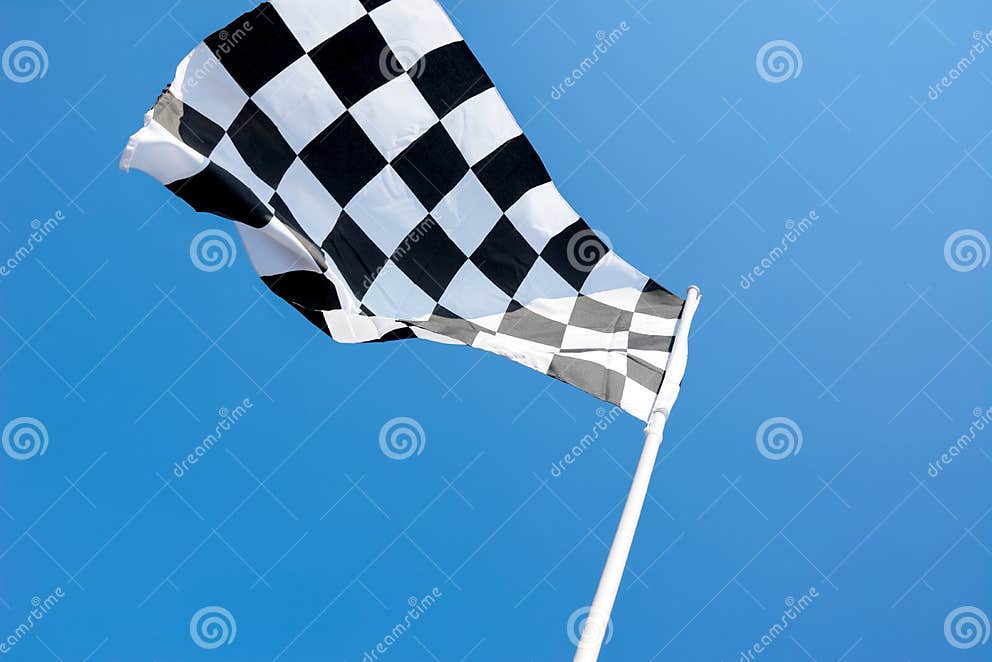 Checkered Flag Flying on Blue Sky Background Stock Image - Image of ...
