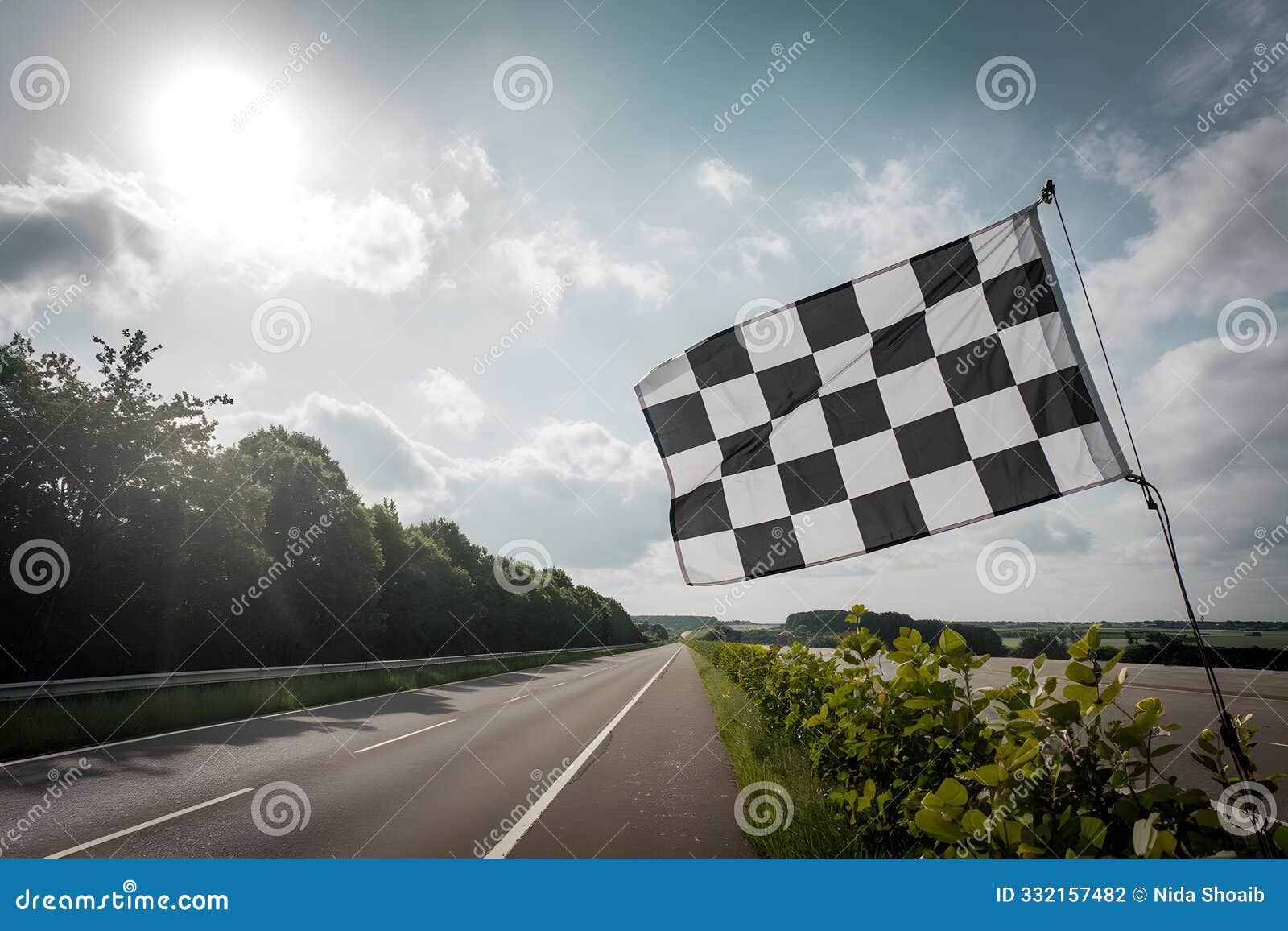 Checkered Flag Waves Over a Straight Road Bordered by Lush Trees Stock ...