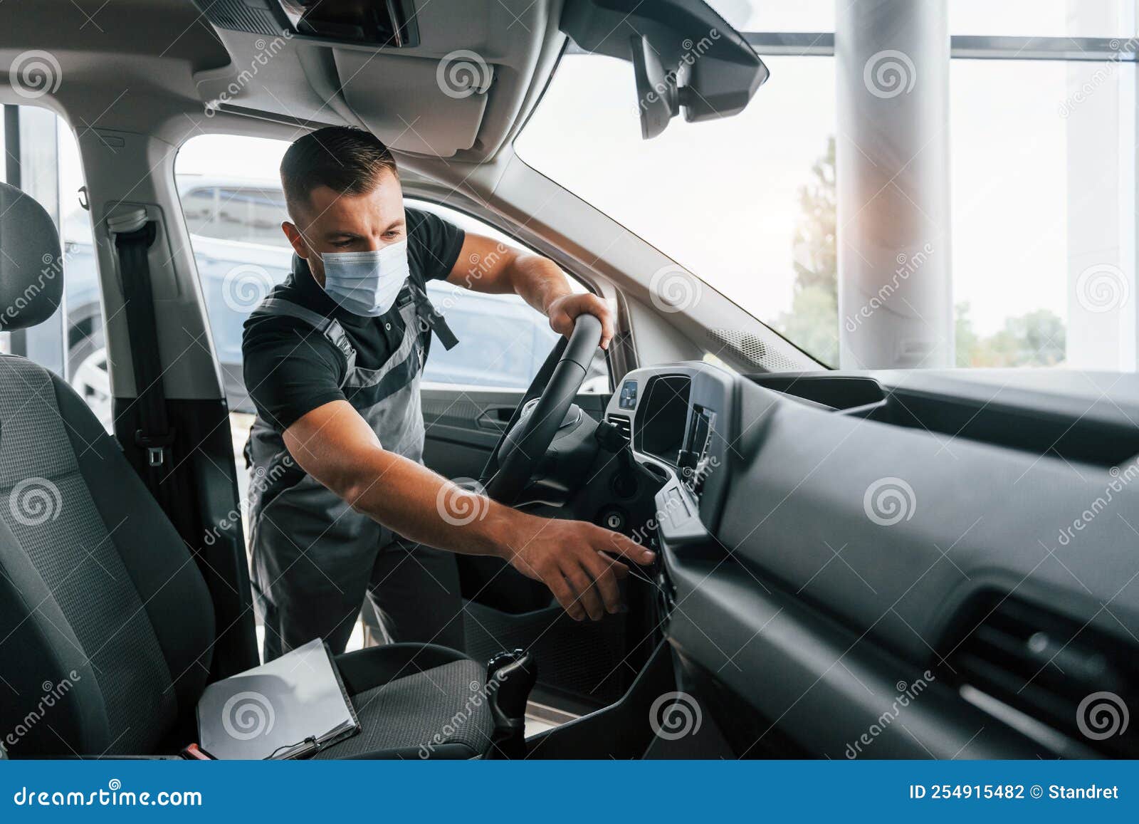 Checking Control Panel. Man in Uniform is Working in the Autosalon at ...