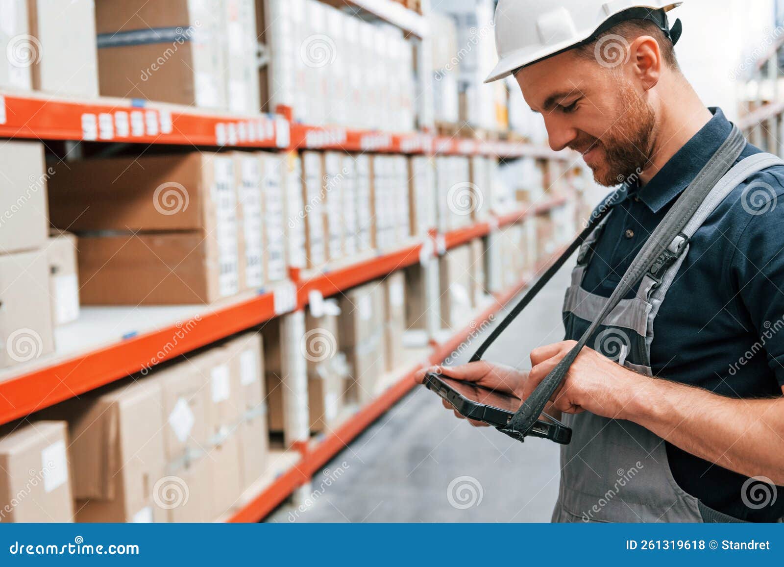 Checking Data in the Tablet. Employee in Uniform is Working in the ...