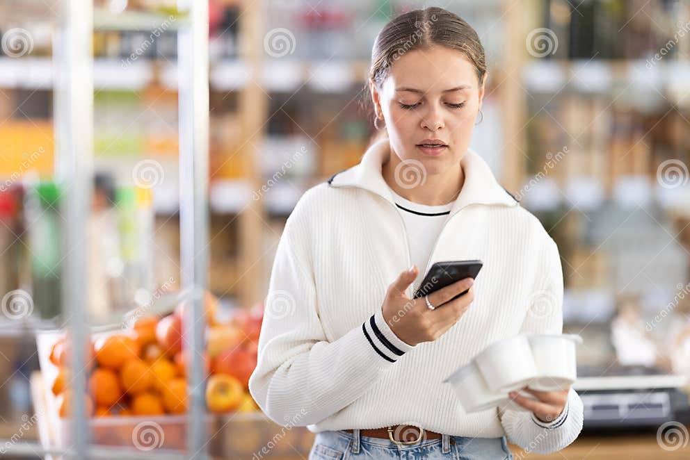 Checking Expiration Date of Yogurt - Female Shopper Scans QR Code on ...