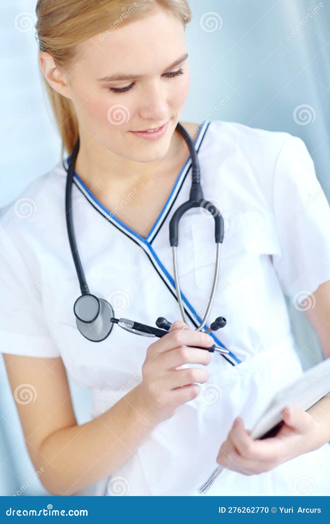 Checking the Files. a Nurse Writing Notes in Her Notepad. Stock Photo ...