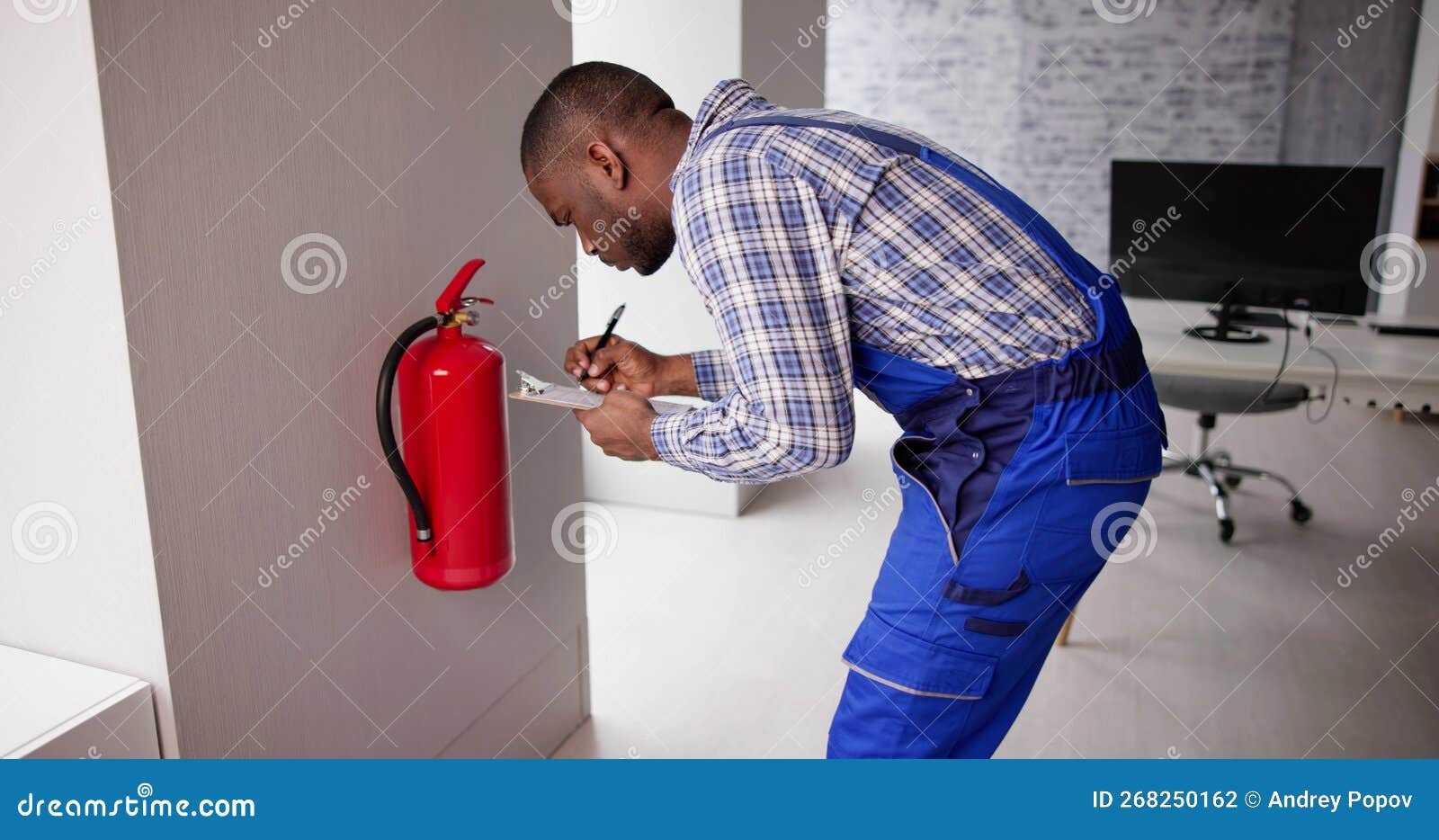 Checking Fire Extinguisher stock photo. Image of checking - 268250162
