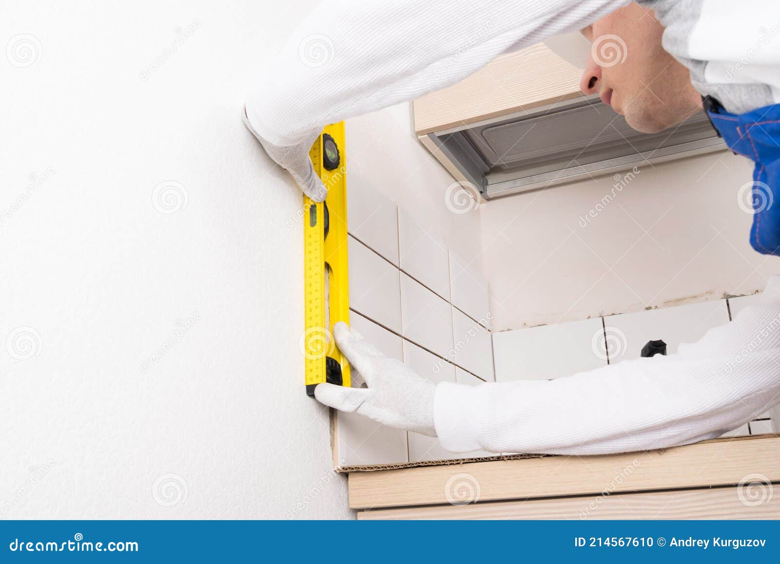 Checking The Tiles In The Bathroom. Quality Control When Laying Ceramic ...