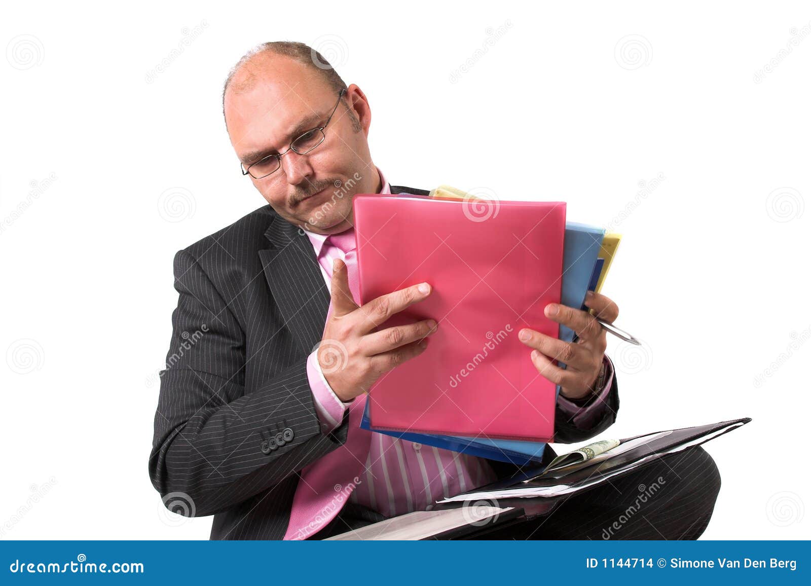 Checking his files stock photo. Image of mature, calculating - 1144714