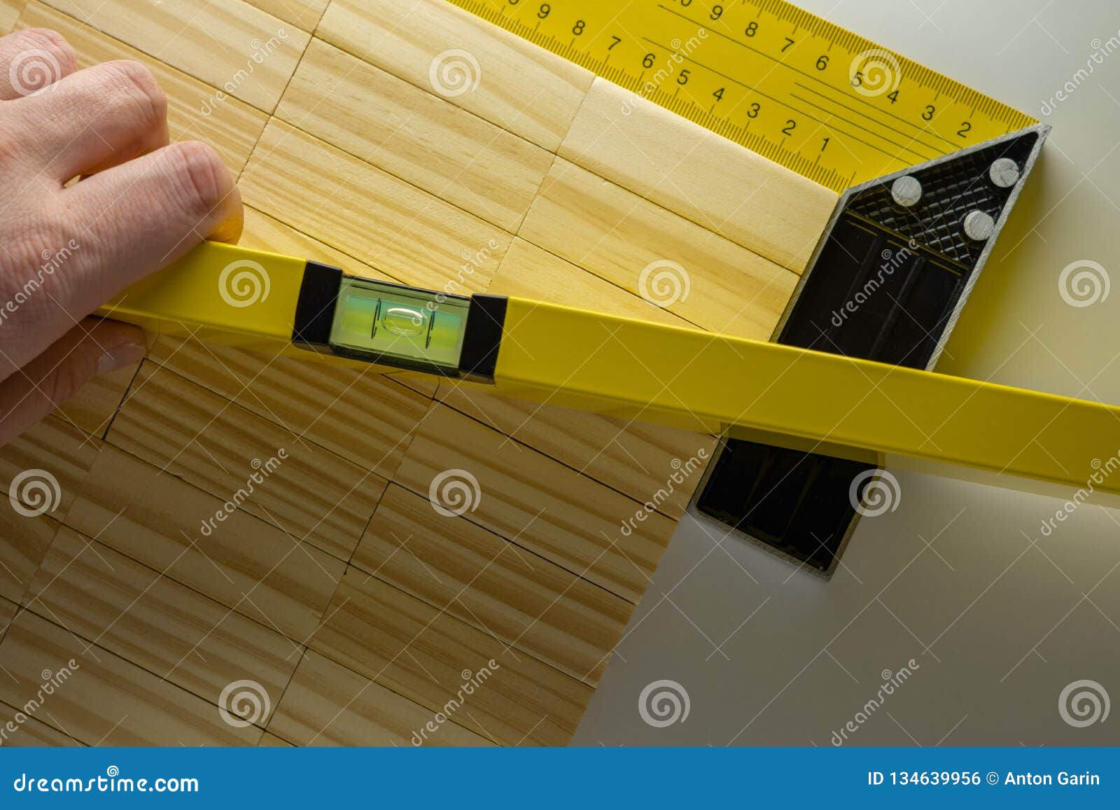 Checking the Level of the Table, Hand with Building Level or Waterpas ...