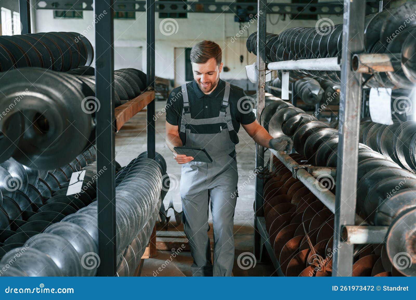 Checking Number of Parts. Man in Uniform is in Workstation Developing ...