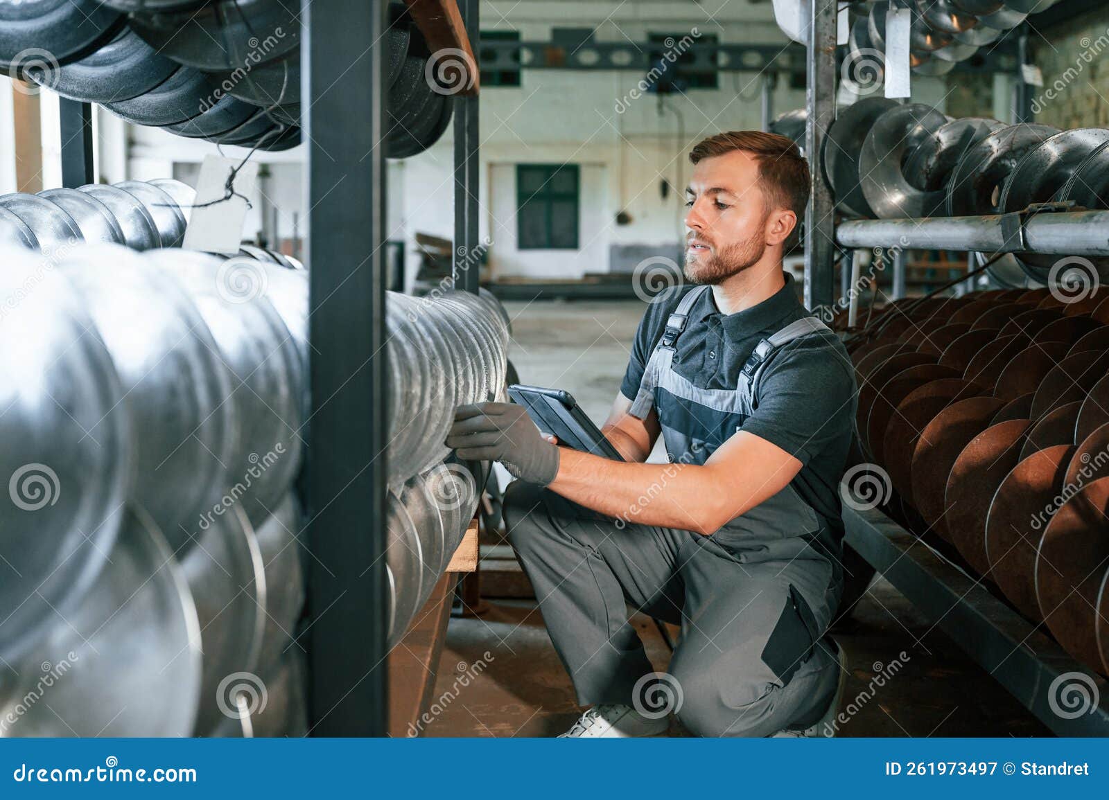 Checking Number of Parts. Man in Uniform is in Workstation Developing ...