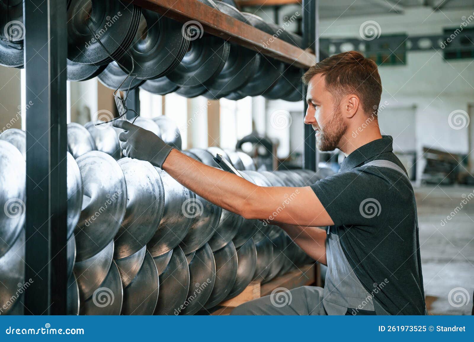 Checking Number of Parts. Man in Uniform is in Workstation Developing ...