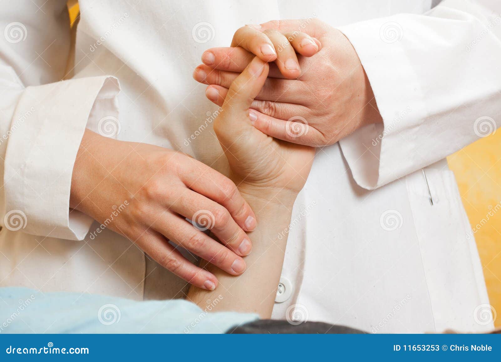 Checking a patients pulse stock image. Image of treating - 11653253