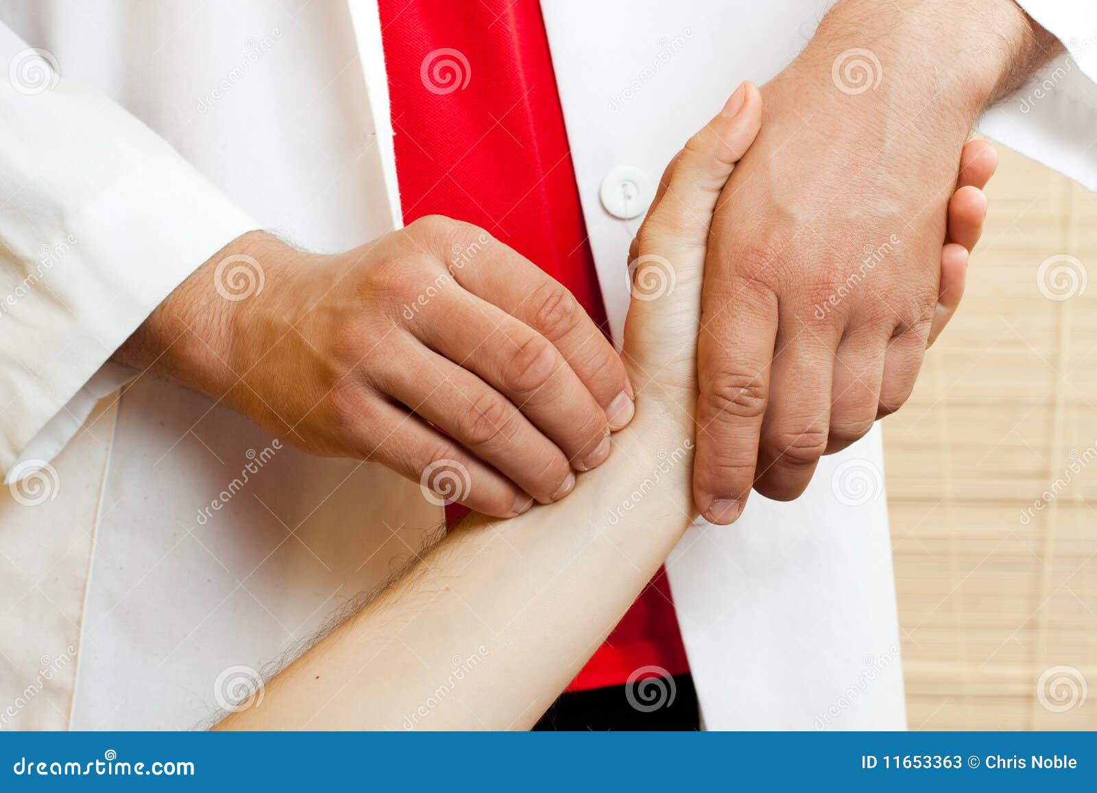 Checking a patients pulse stock image. Image of medicine - 11653363