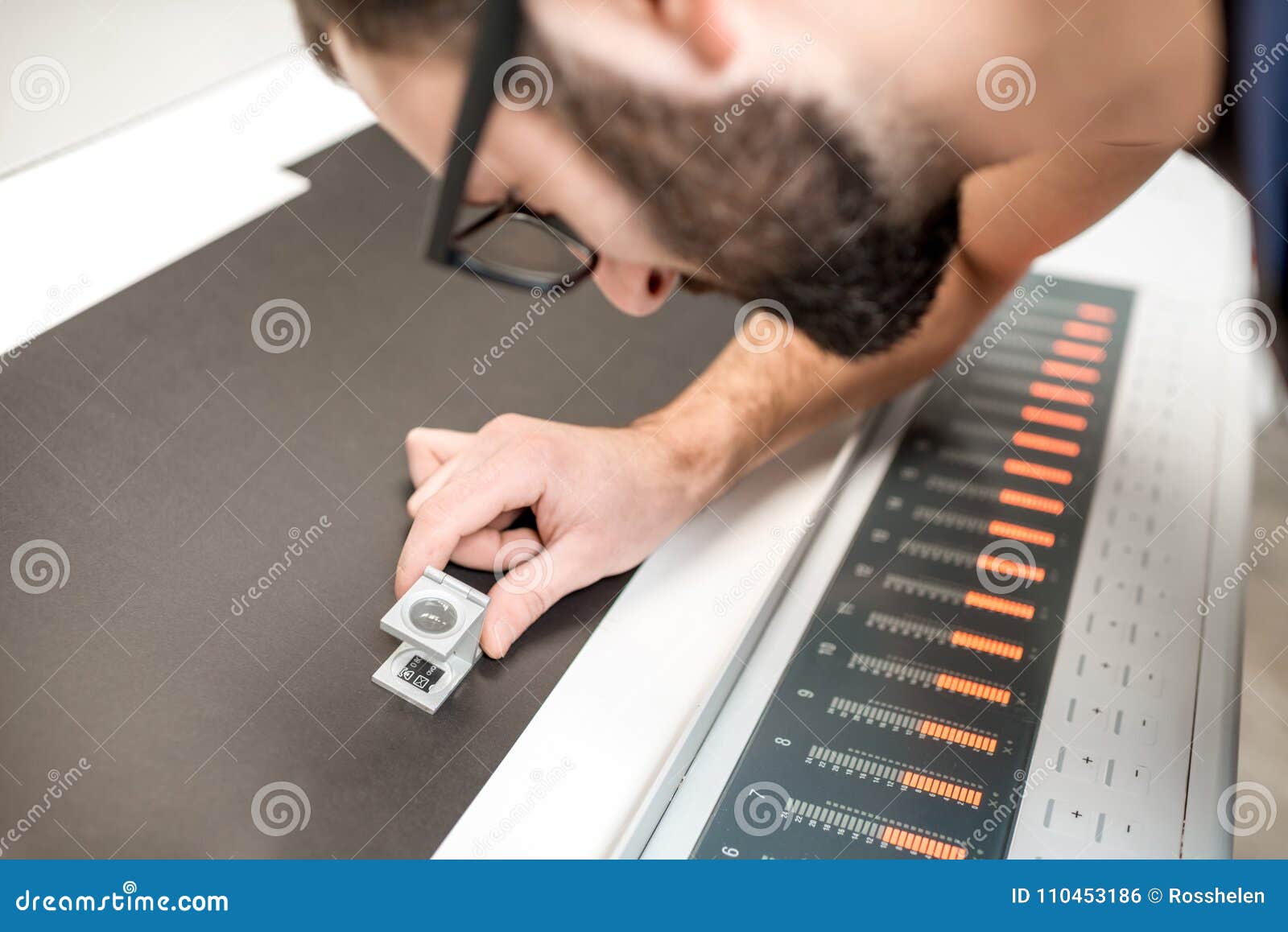 Checking the Quality of the Printing with Magnifying Glass Stock Photo ...