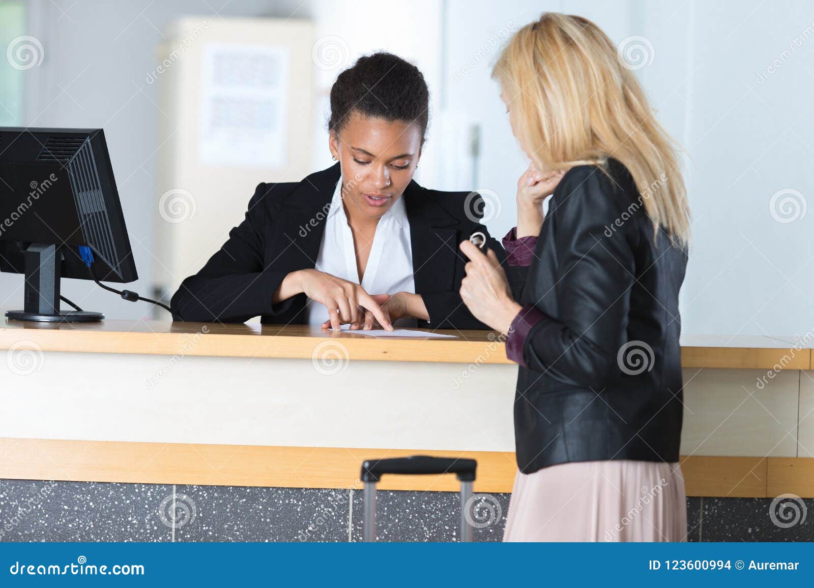 Checking the Reservation List Stock Photo - Image of receptionist ...