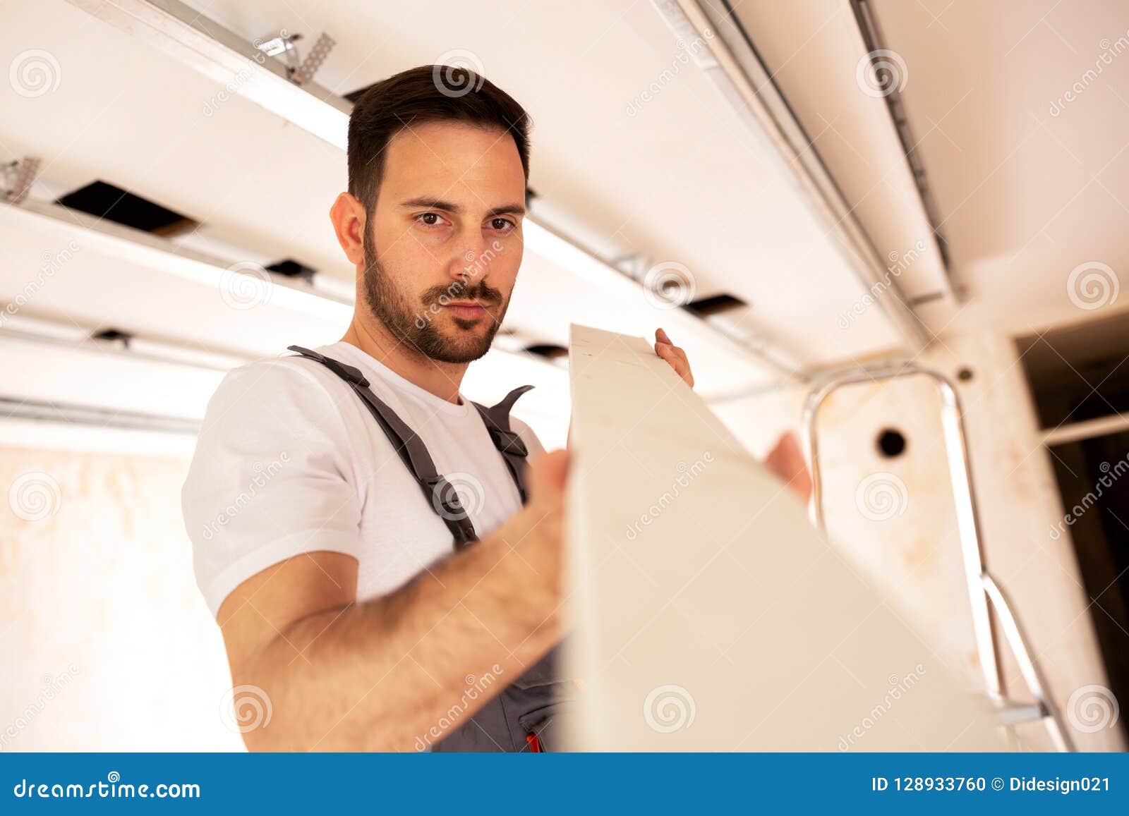 Checking the Surface Smoothness of a Ceiling Element Stock Photo ... Checking the Surface Smoothness of a Ceiling Element Stock Photo ...