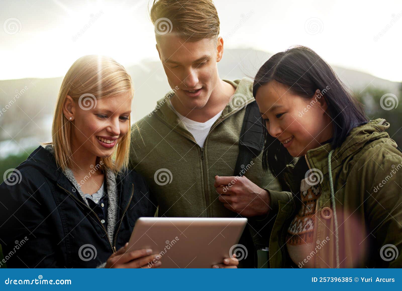 Checking Their Assignments Online. Three Young Students Looking at a ...