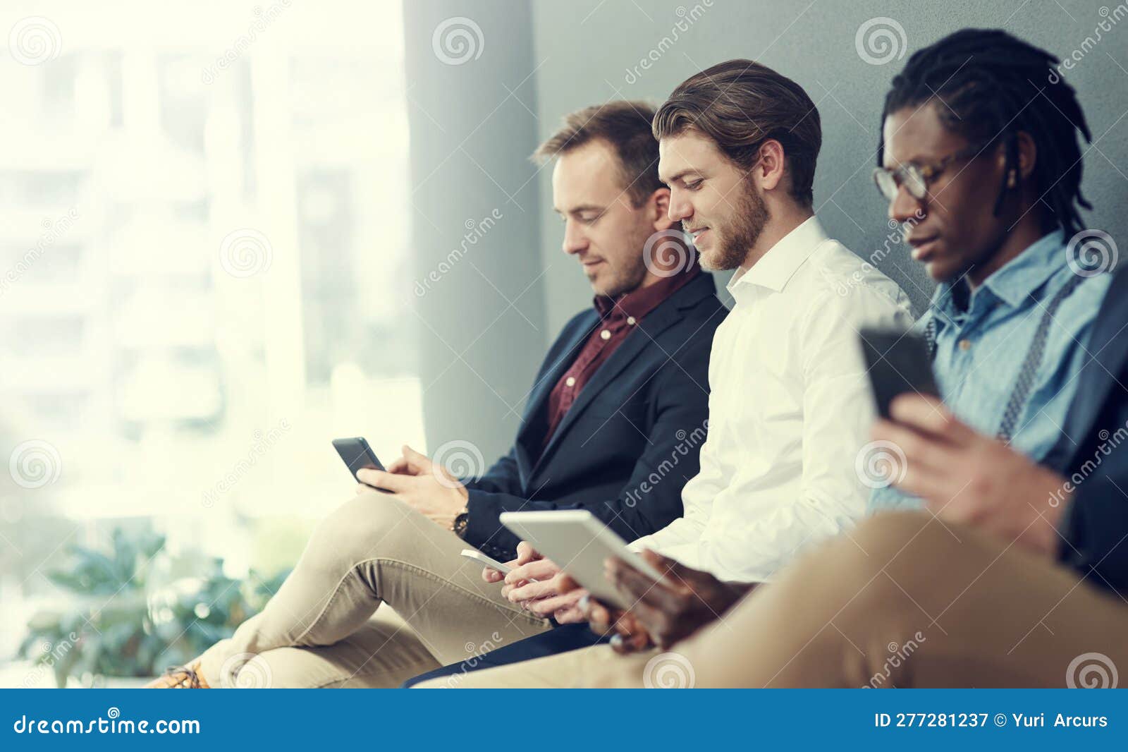 Checking Their Social Platforms while they Wait. a Group of Businessmen ...