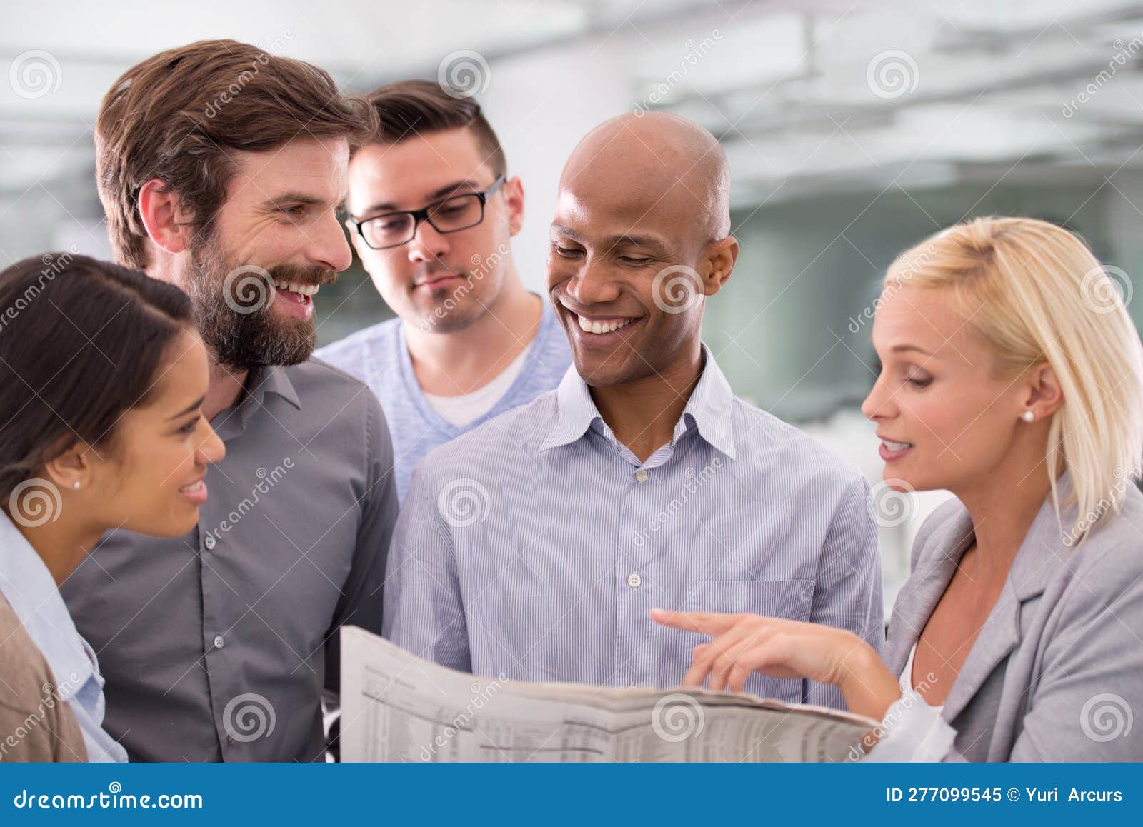 Checking Up on the Stock Figures. a Group of Work Colleagues Reading a ...