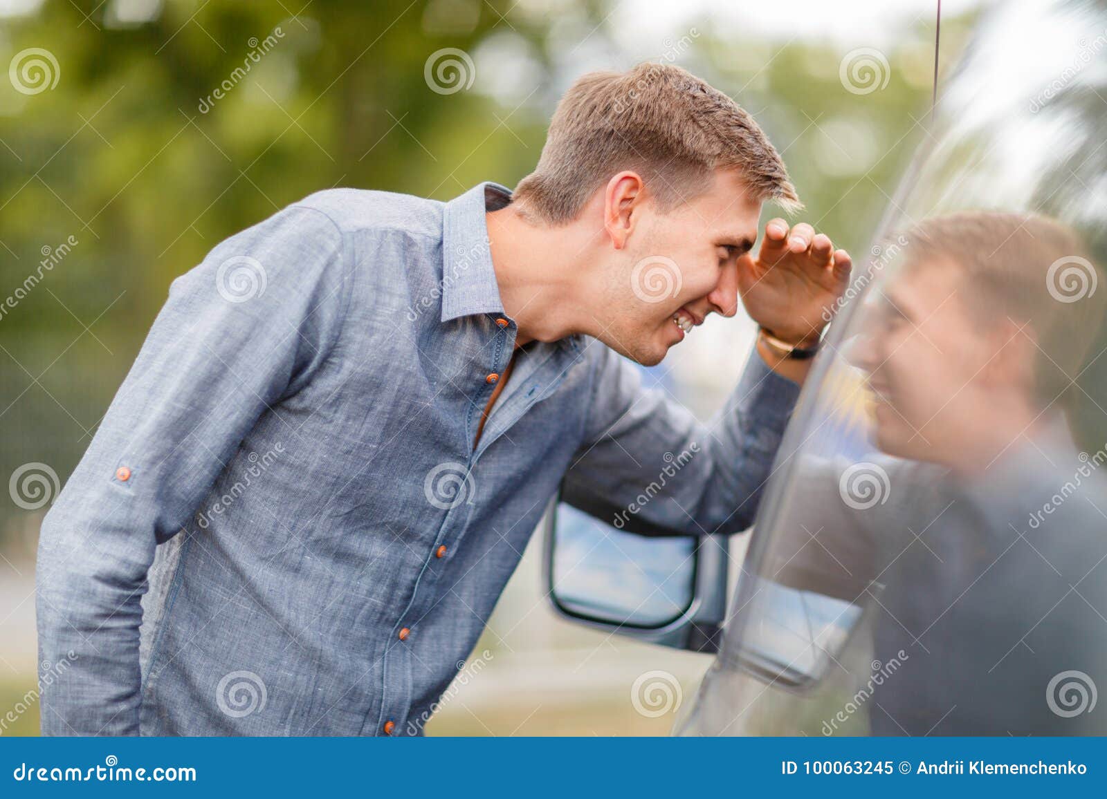 A Young Man Checks a Used Car. Used Car Theme. Stock Image - Image of ...
