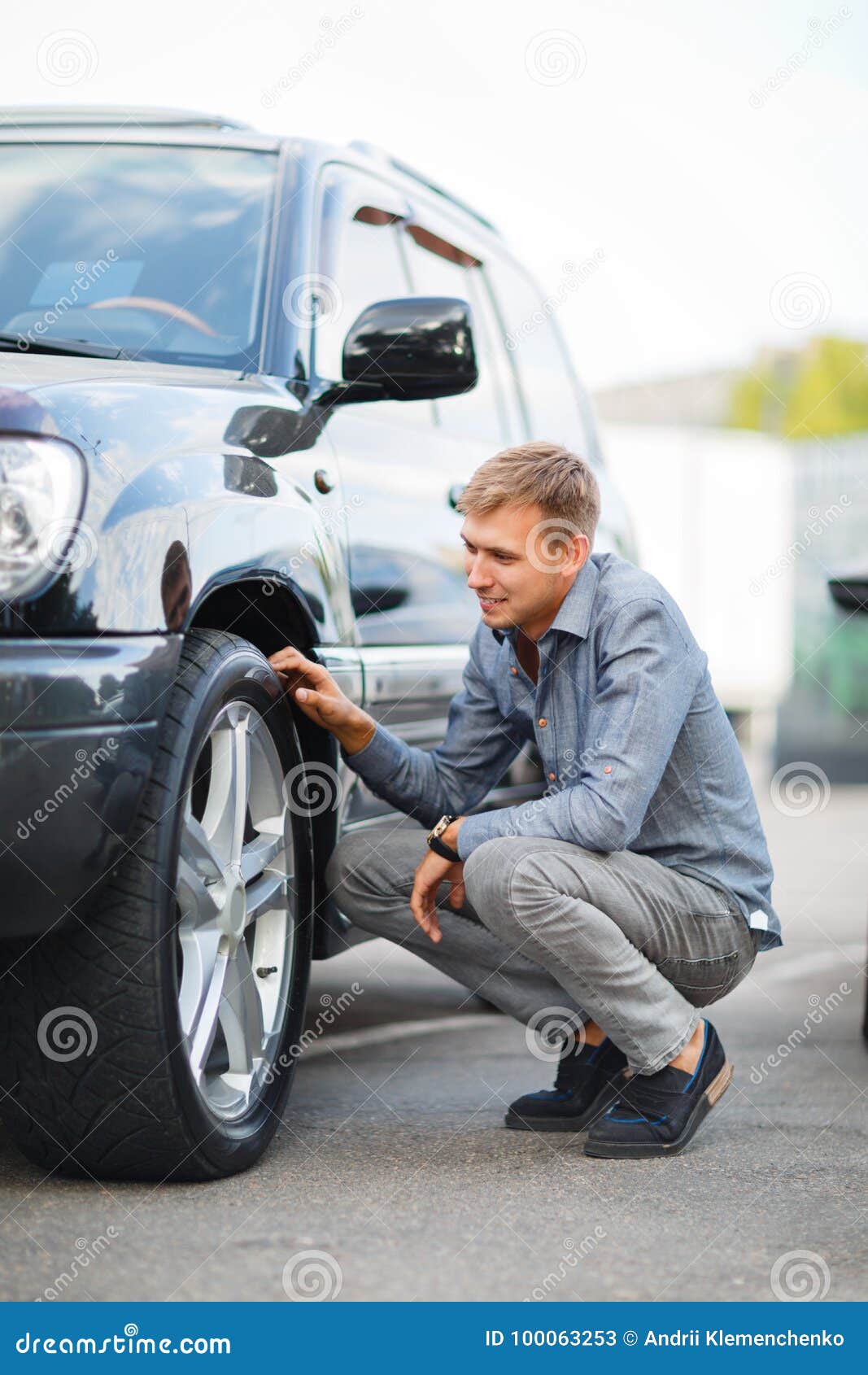 A Young Man Checks a Used Car. Used Car Theme. Stock Image - Image of ...