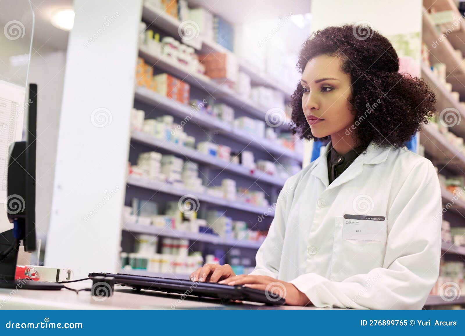 Checking Which Prescriptions are Ready for Refills. a Pharmacist ...