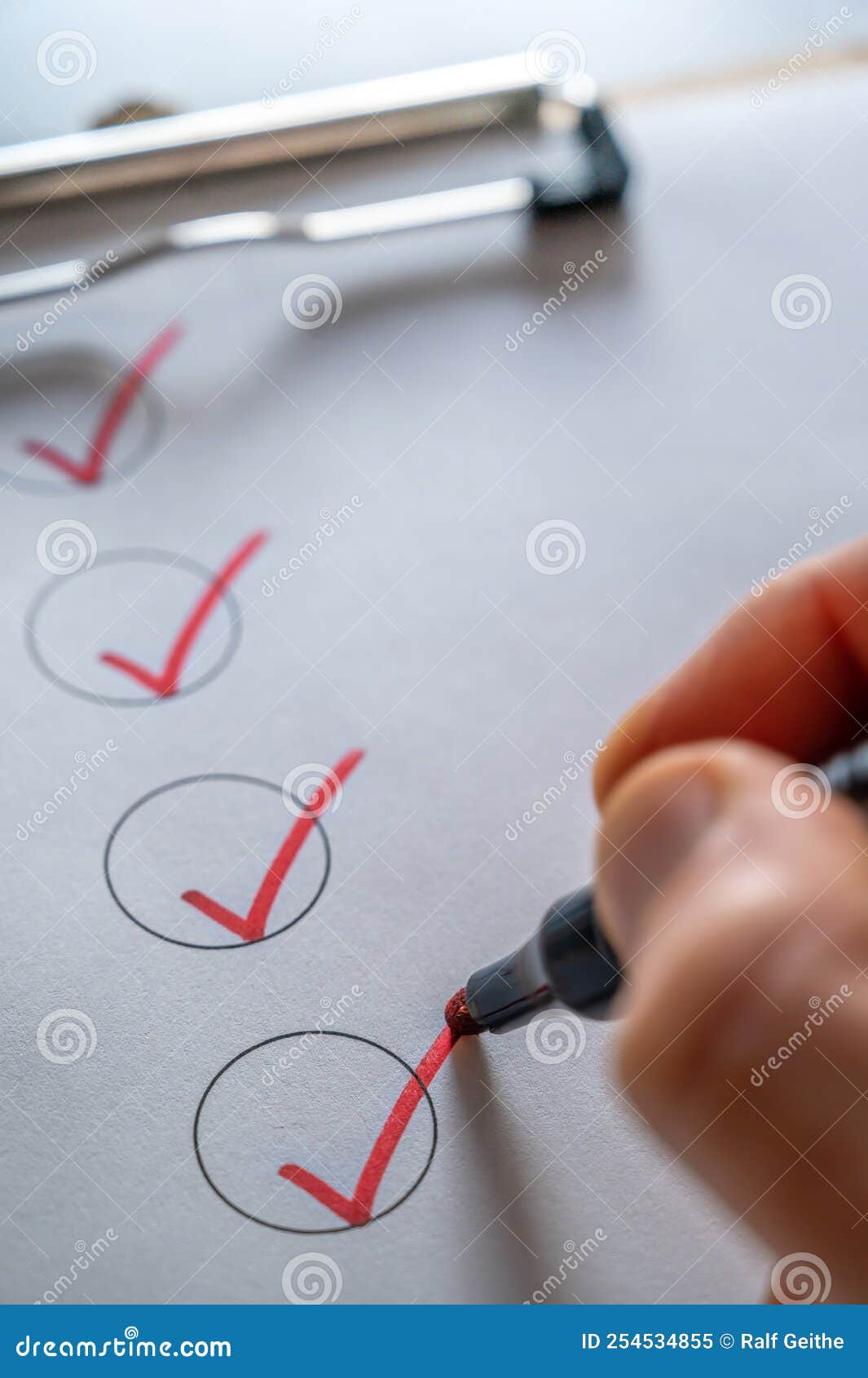 Checking Off a Checklist on a Clipboard on a Table Stock Image - Image ...