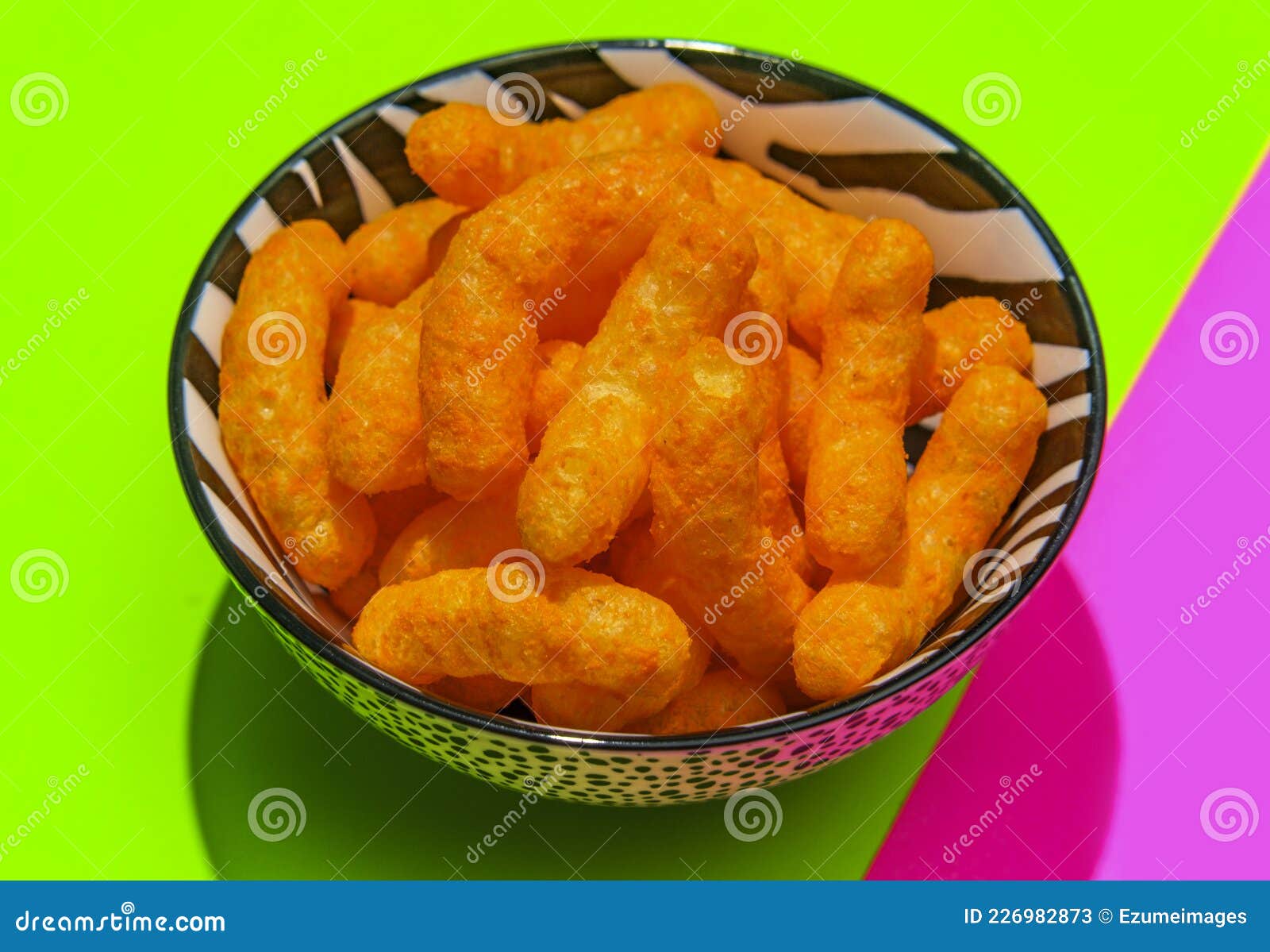 Cheddar Cheese Curls Snack stock image. Image of geometry - 226982873