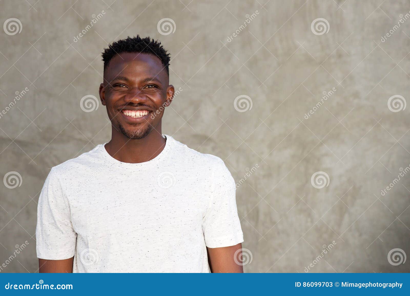 Cheerful African Man Smiling by Wall with Copy Space Stock Image ...