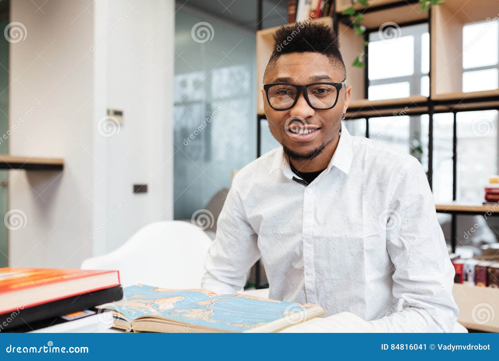 Cheerful African Student Learning Education Material with Books Stock ...