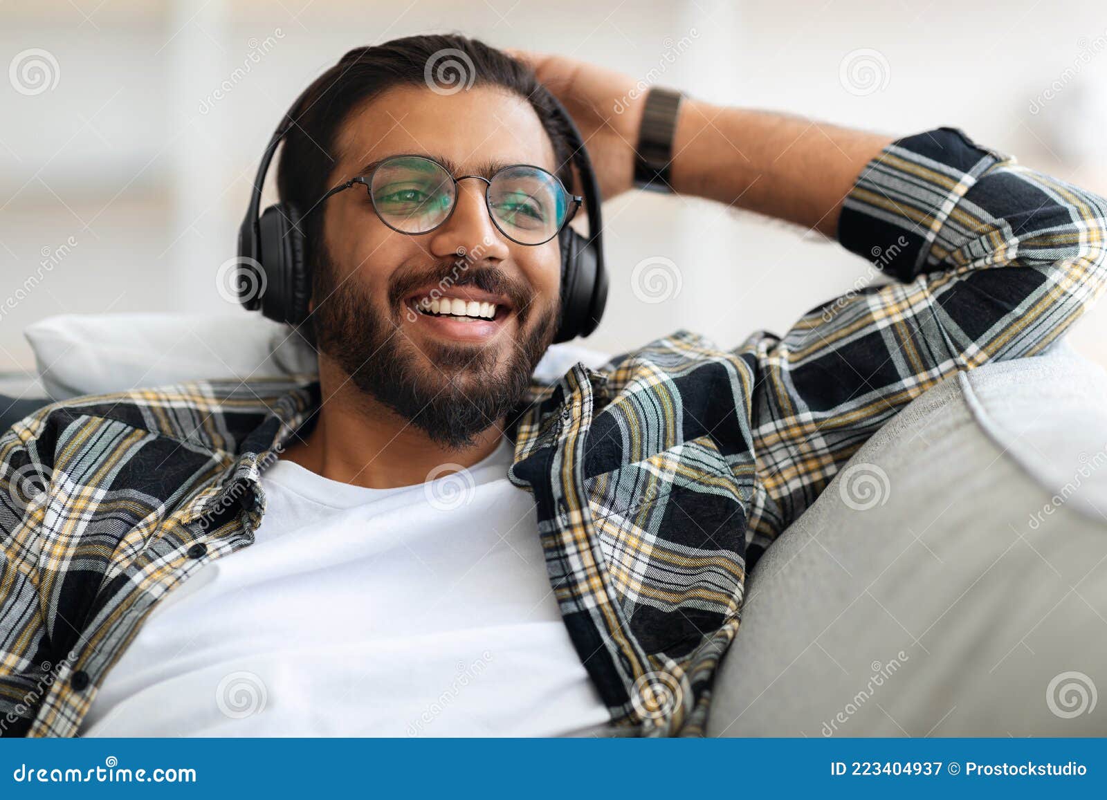 Cheerful Arab Guy Listening To Music, Using Wireless Headset Stock ... Cheerful Arab Guy Listening To Music, Using Wireless Headset Stock ...