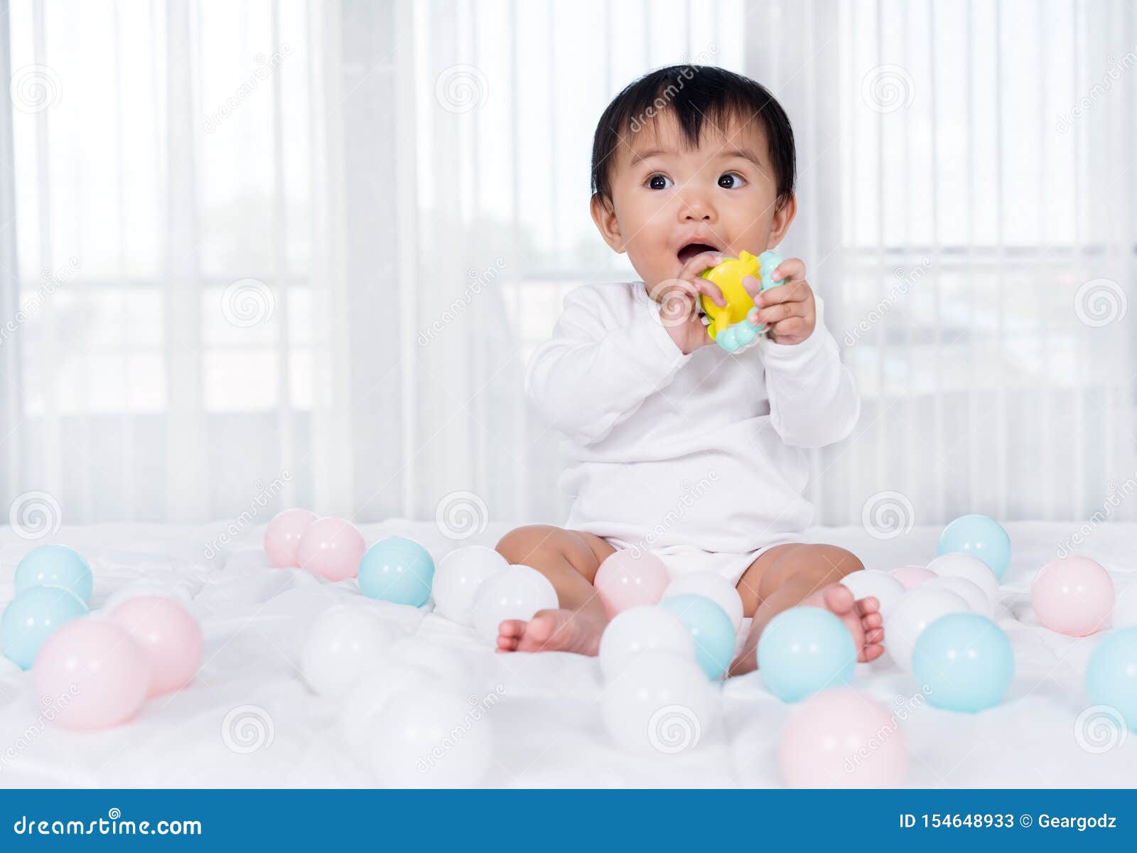 Cheerful Baby Playing Color Ball on Bed Stock Image - Image of ...
