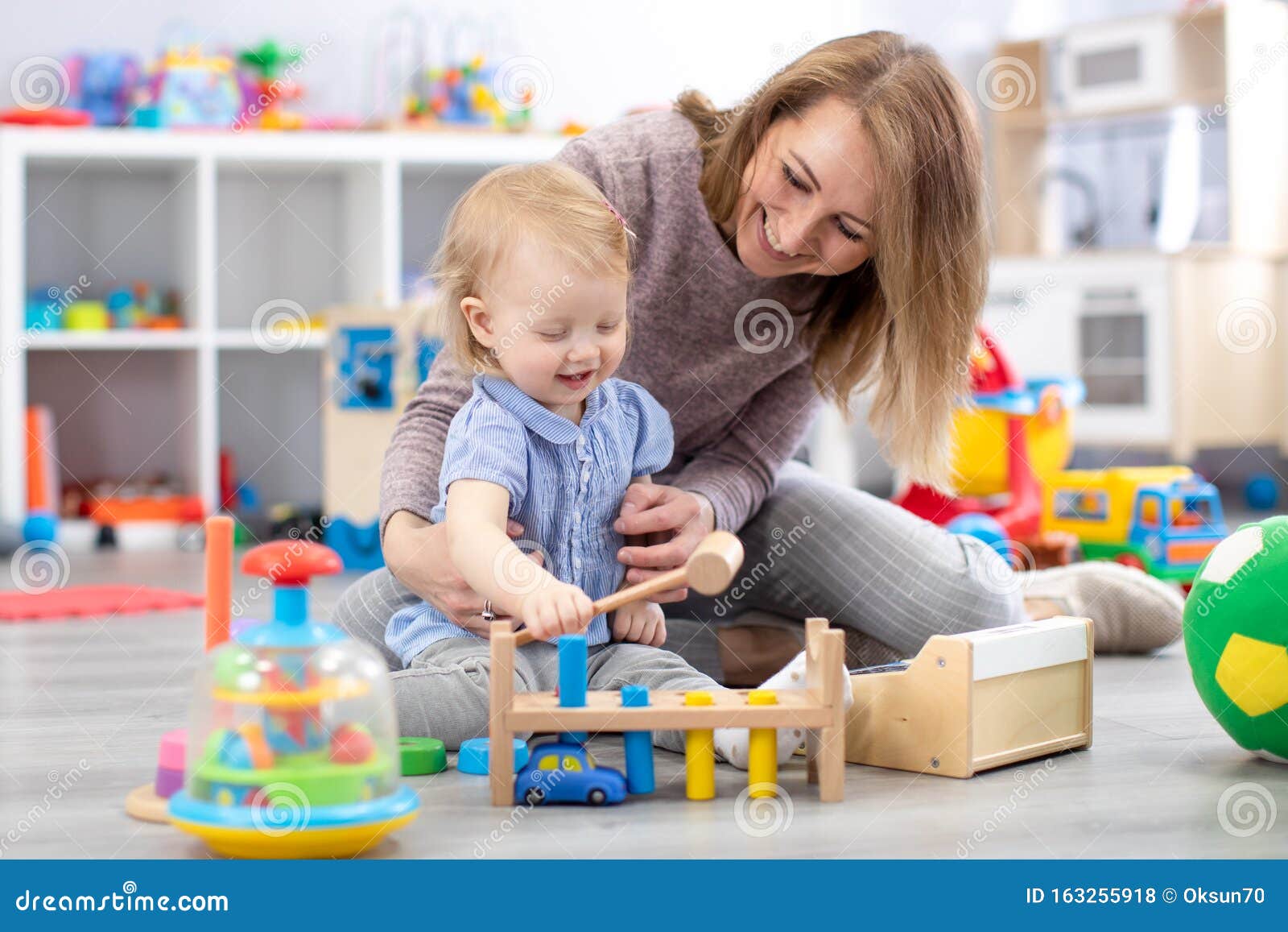 Cheerful Baby Playing with Toys with Happy Mother in Nursery Stock ... Cheerful Baby Playing with Toys with Happy Mother in Nursery Stock ...